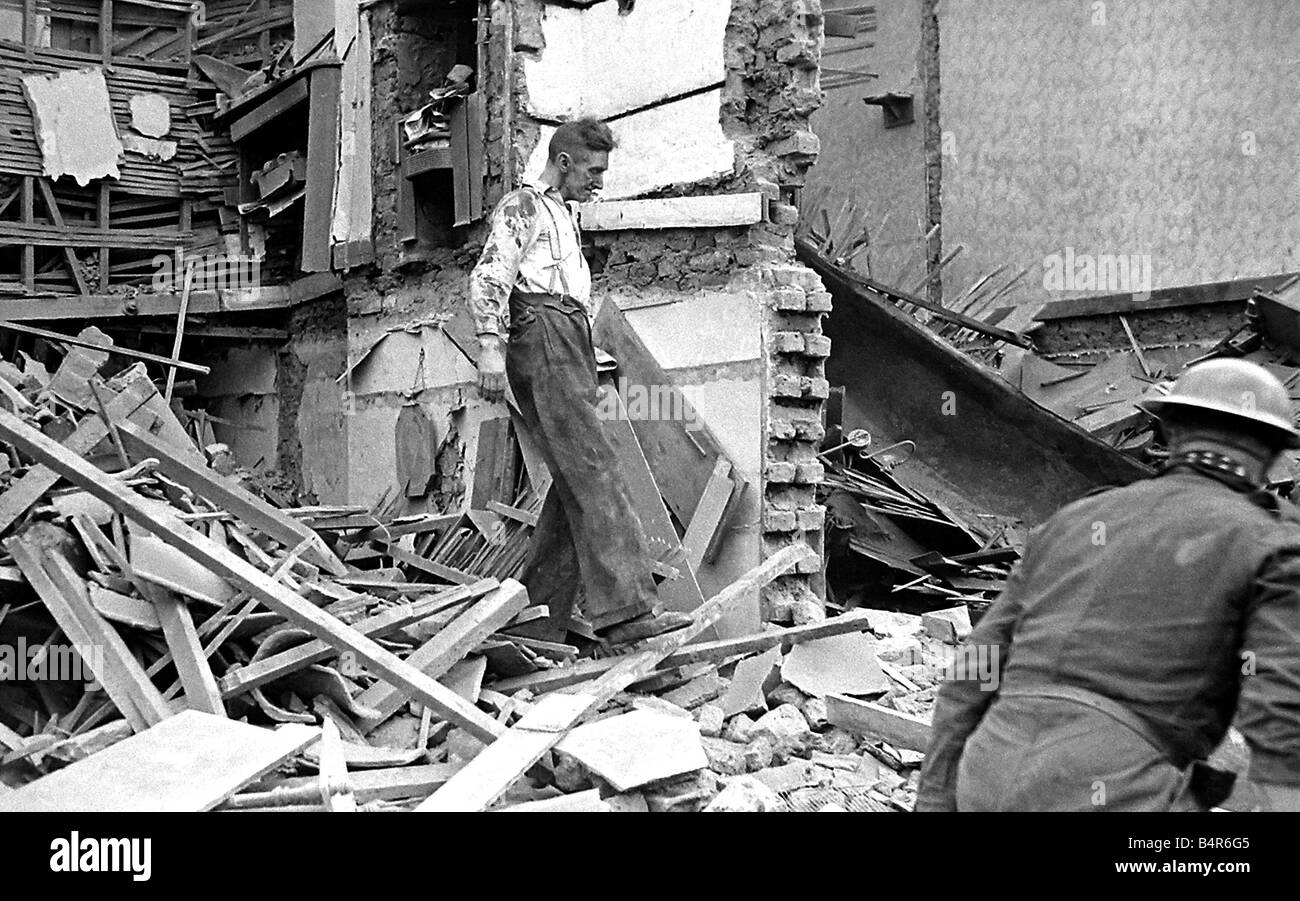 A man wades through the debris of bomb damage in Kings Cross after air ...
