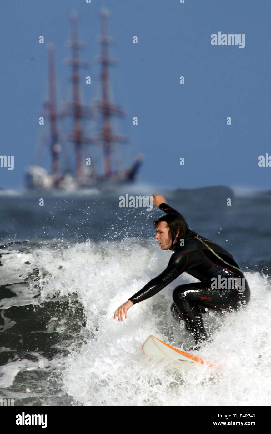 Tall Ships Race July 2005 A Surfer rides the waves at tynemouth beach ...