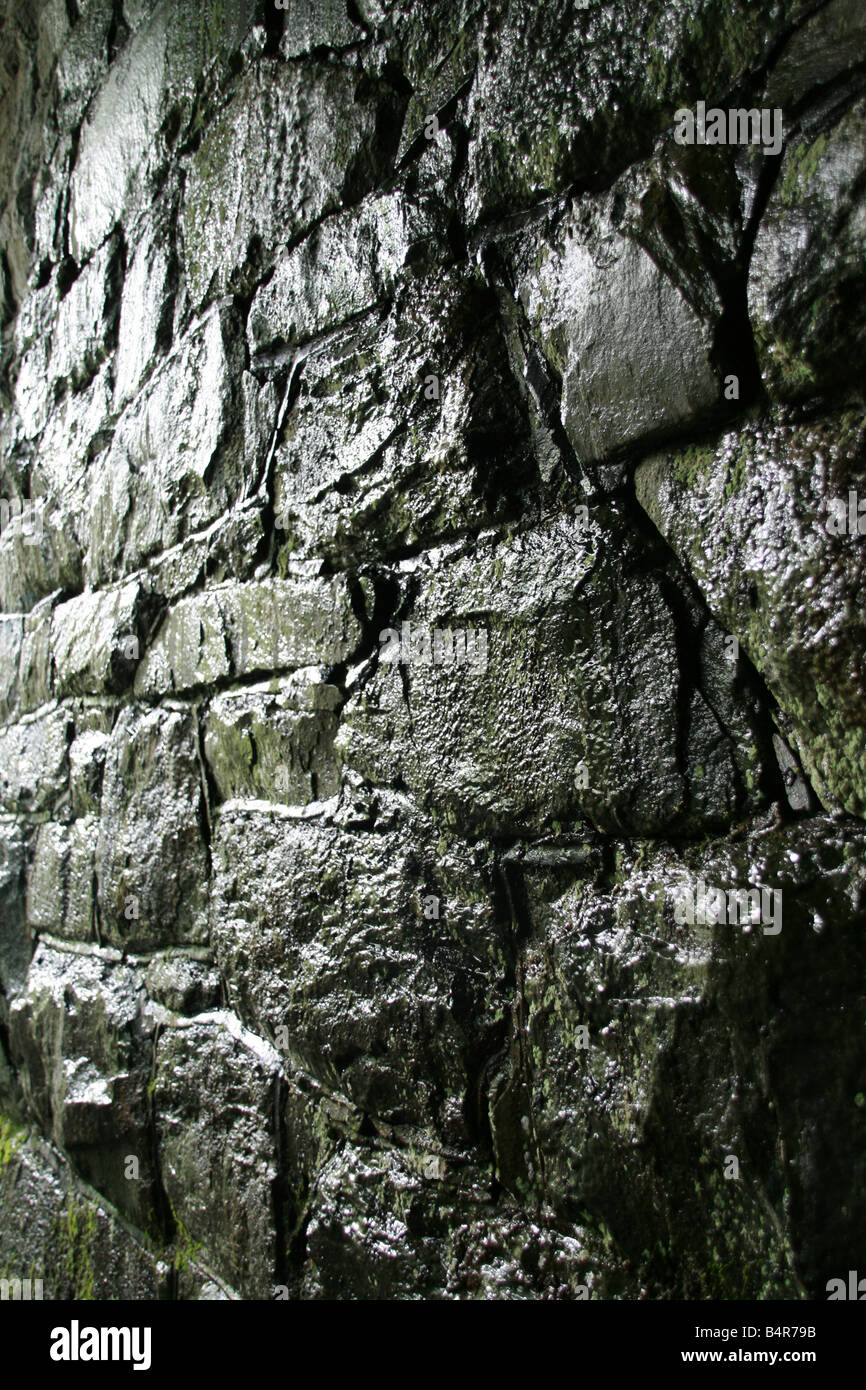 detail of dark damp wet stone wall in alley way Stock Photo - Alamy