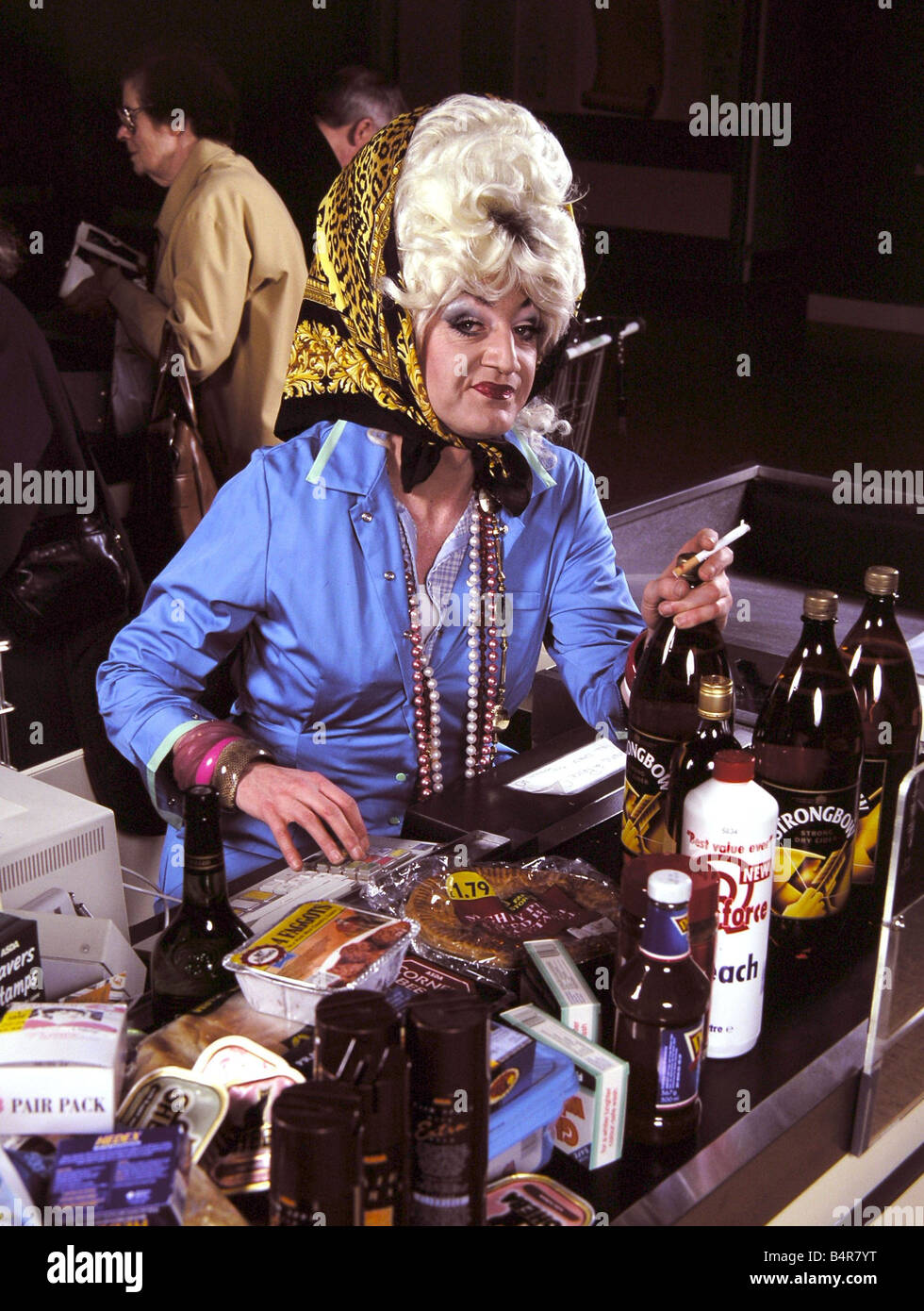 Comedian Paul O Grady aka Lily Savage smoking a cigarette as she sits ...