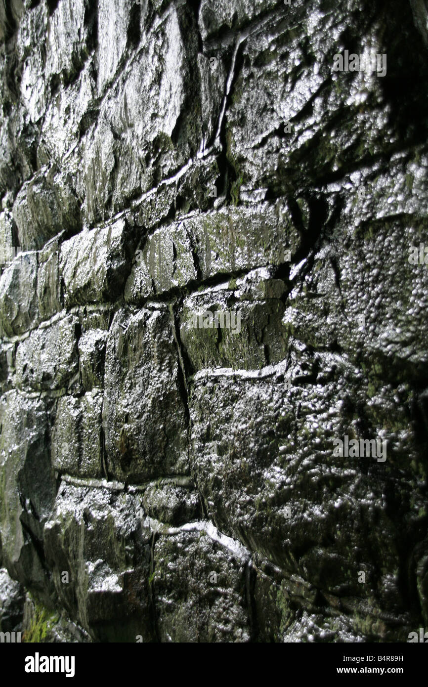 detail of dark damp wet stone wall in alley way Stock Photo - Alamy