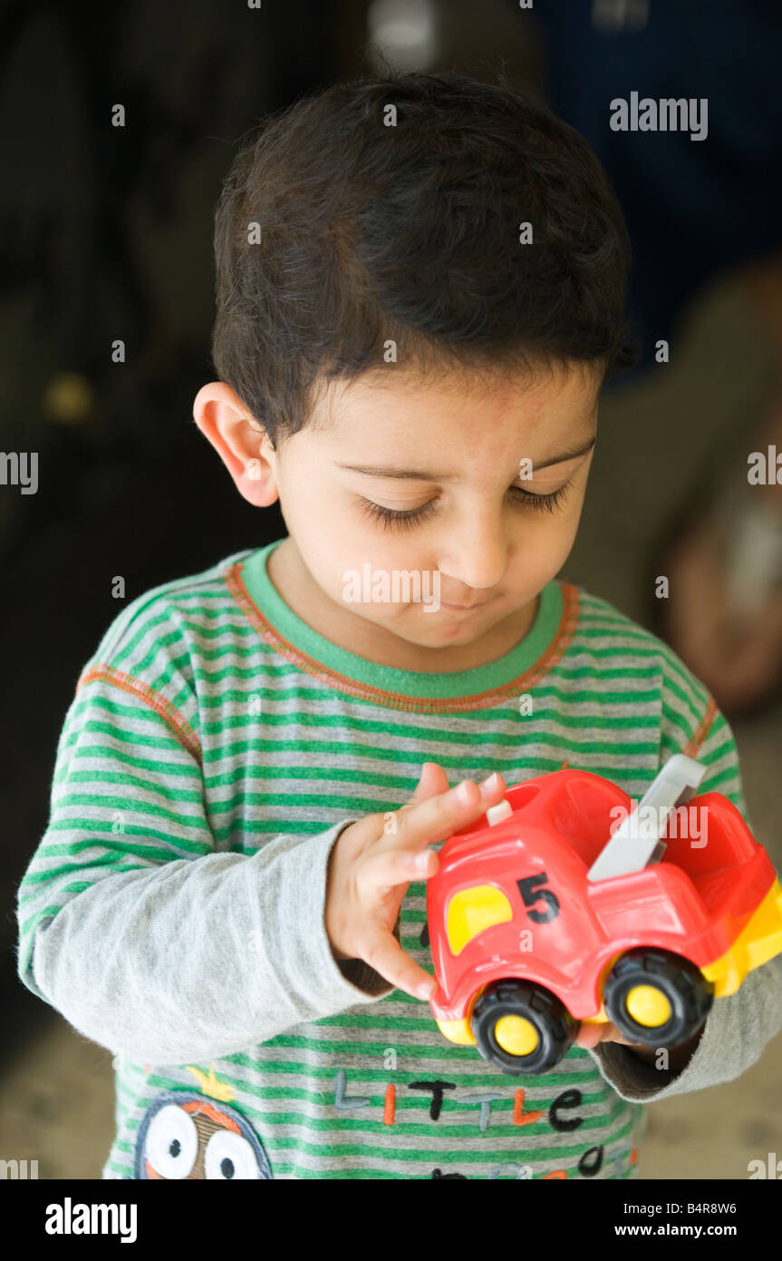 Child playing with red toy car Stock Photo - Alamy