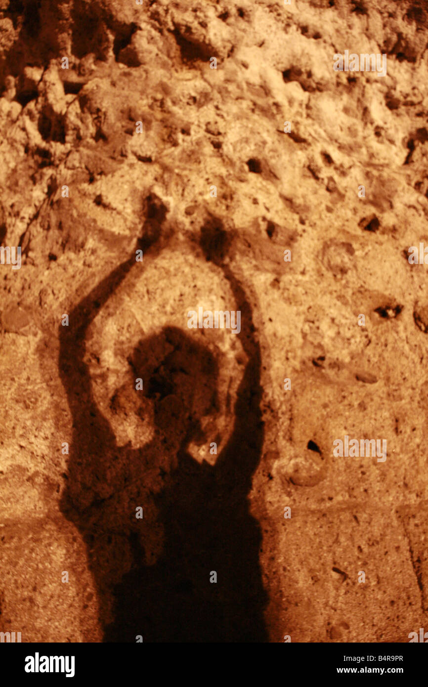 one person's dark shadow on rock wall at night Stock Photo - Alamy