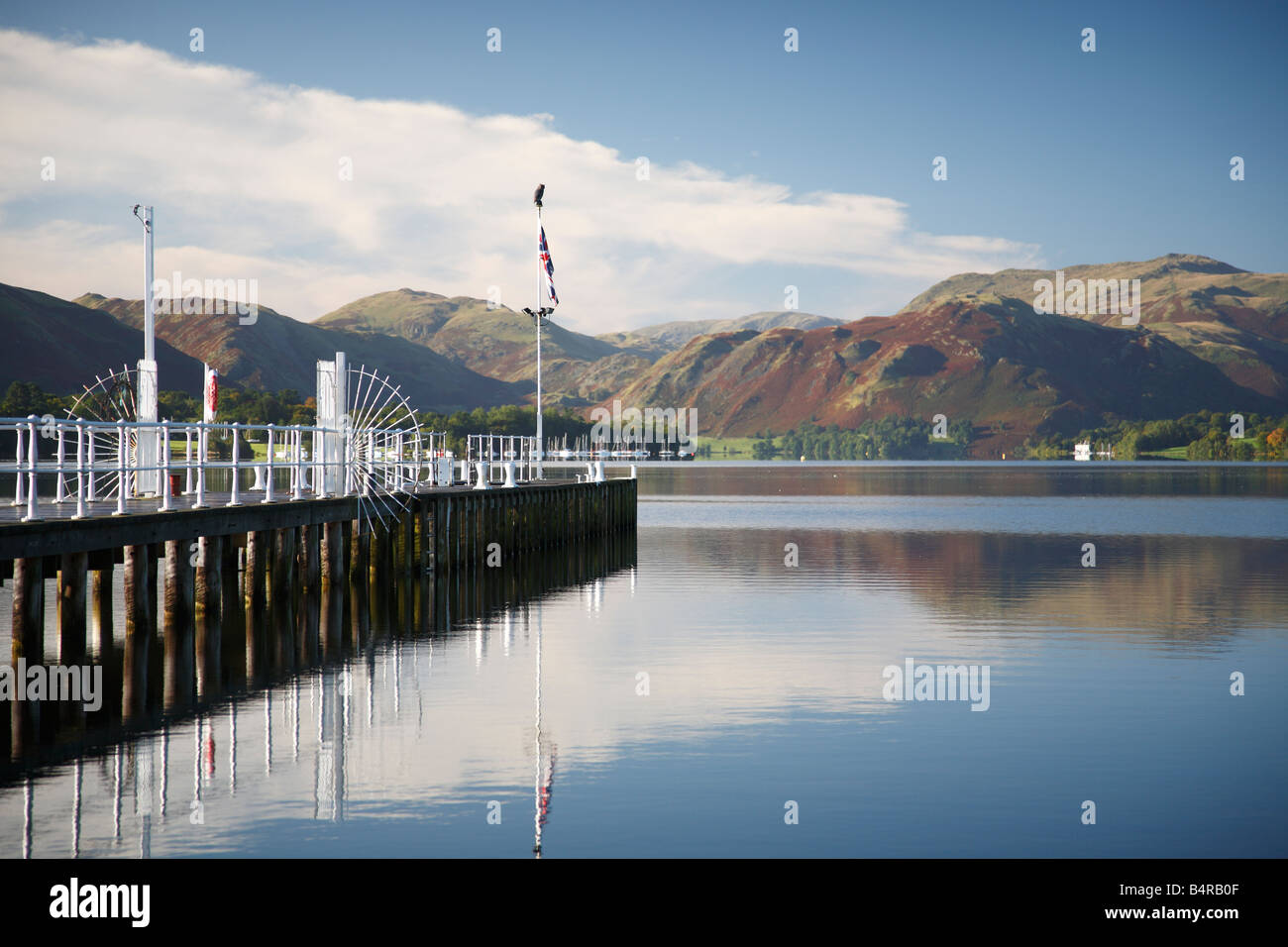 Lake scene with jetty, trees and hills. Pooley Bridge, The Lake ...