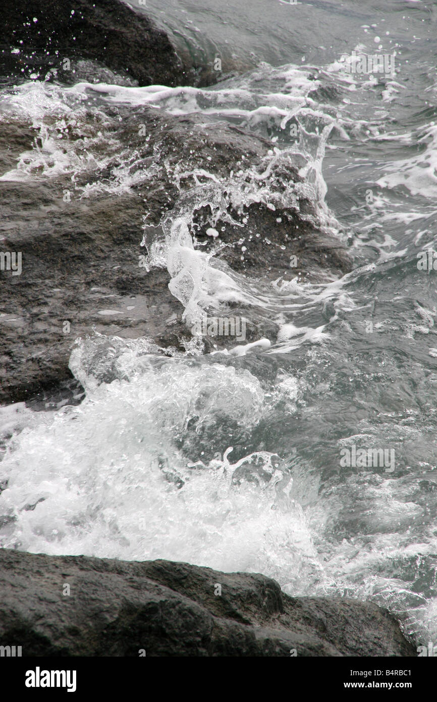 The sea crashing over rocks in Lyme Regis Dorset Stock Photo - Alamy