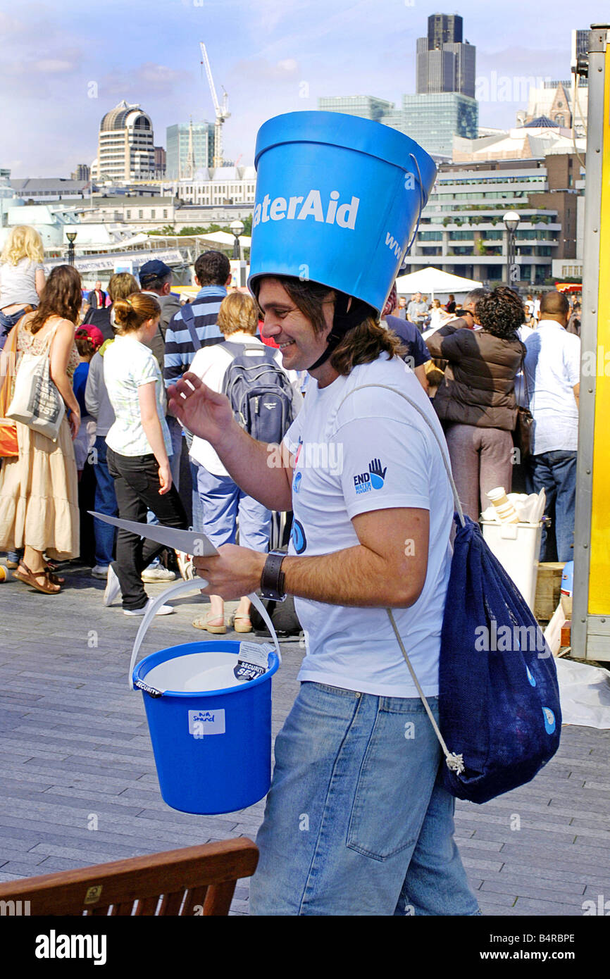 A man collecting money for the charity WaterAid at the London thames ...