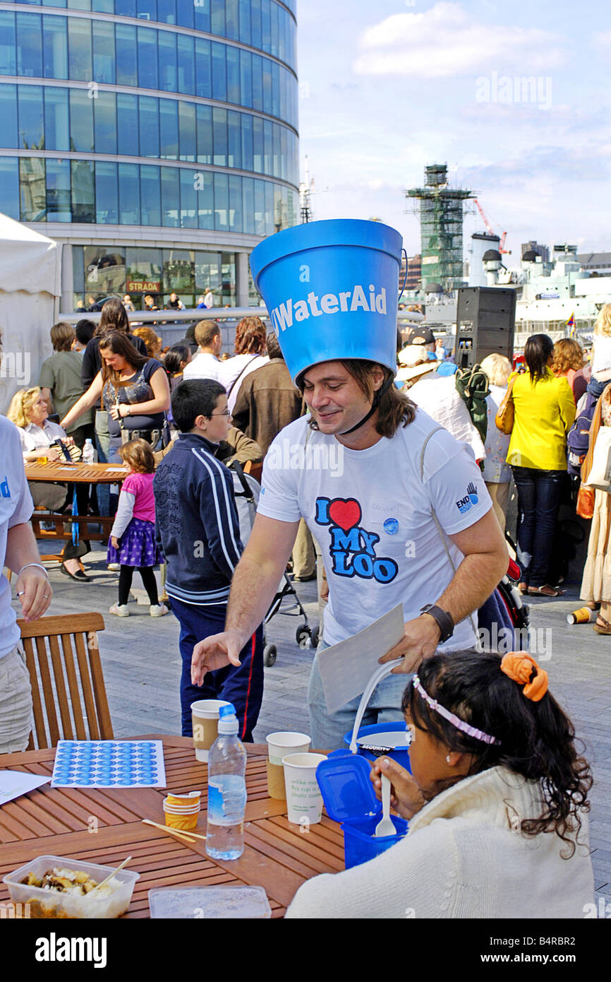 A man collecting money for the charity WaterAid at the London thames ...