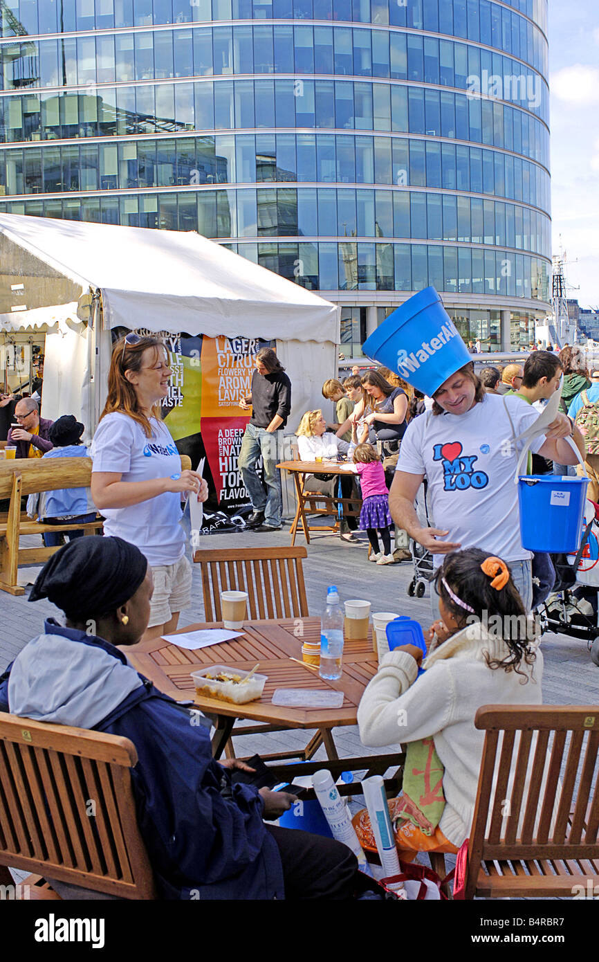 A man collecting money for the charity WaterAid at the London thames ...