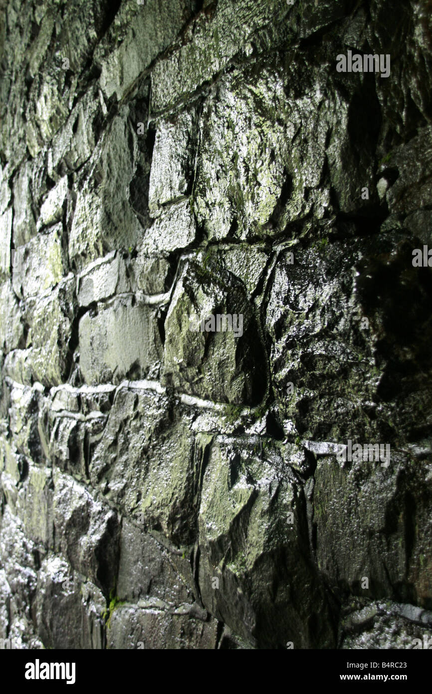 detail of dark damp wet stone wall in alley way Stock Photo - Alamy
