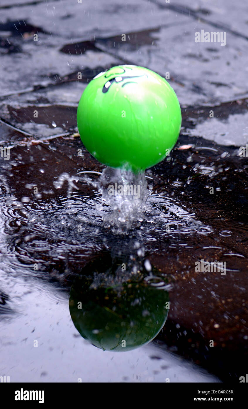A ball bouncing in a puddle Stock Photo - Alamy