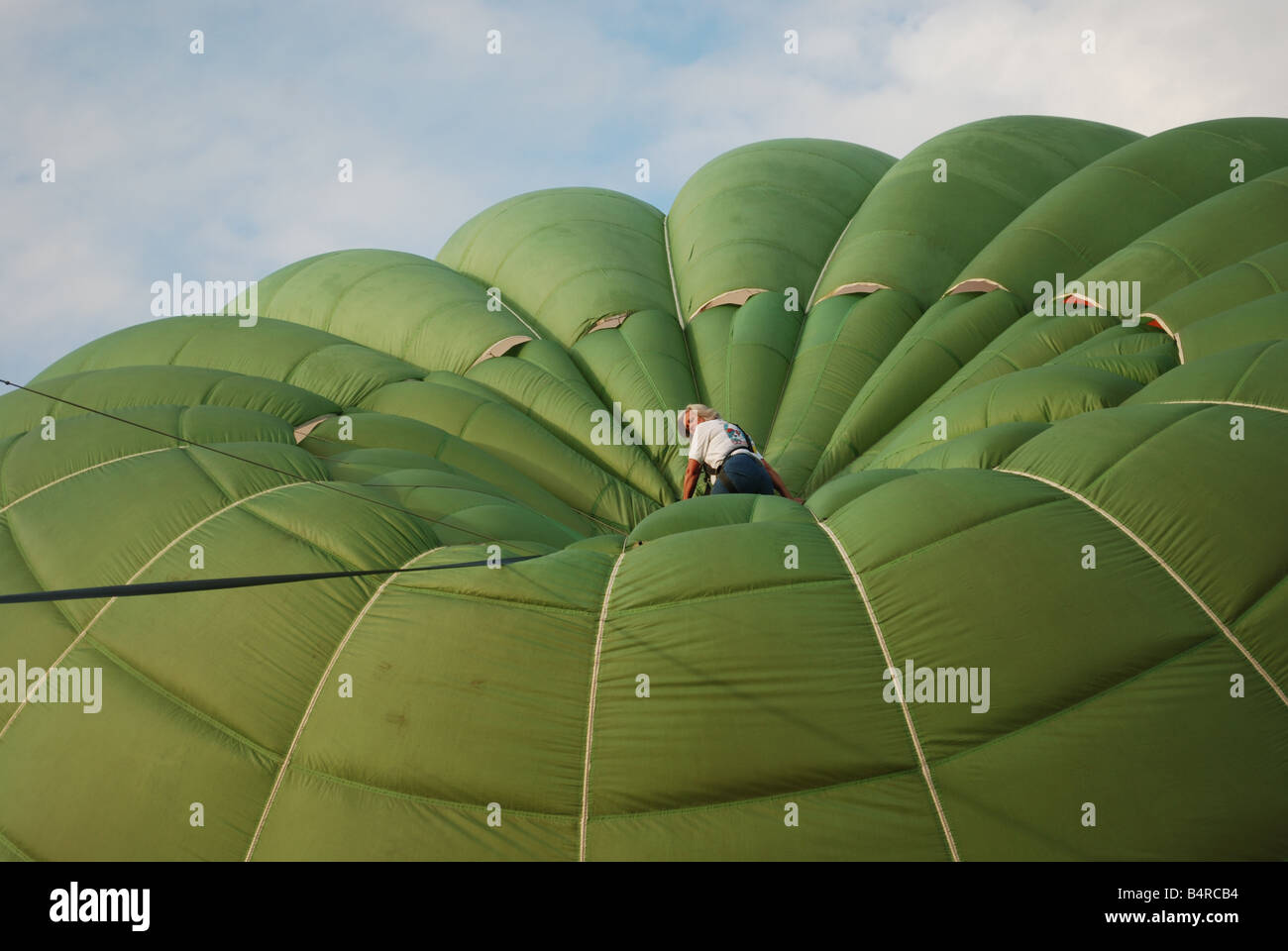 person on top of inflated hot air balloon Stock Photo - Alamy