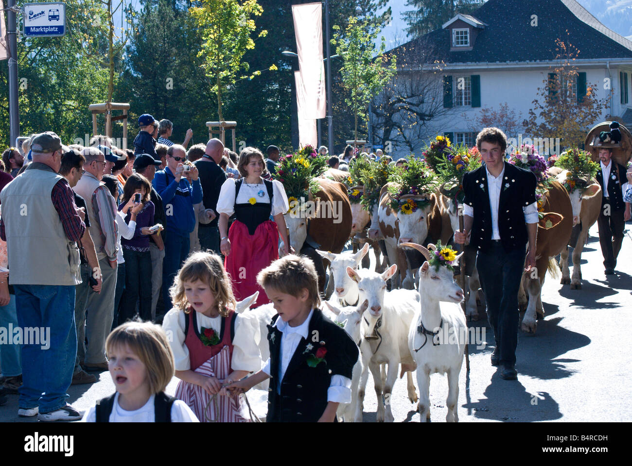 Swiss children and adults dressed in traditional folk costumes lead ...