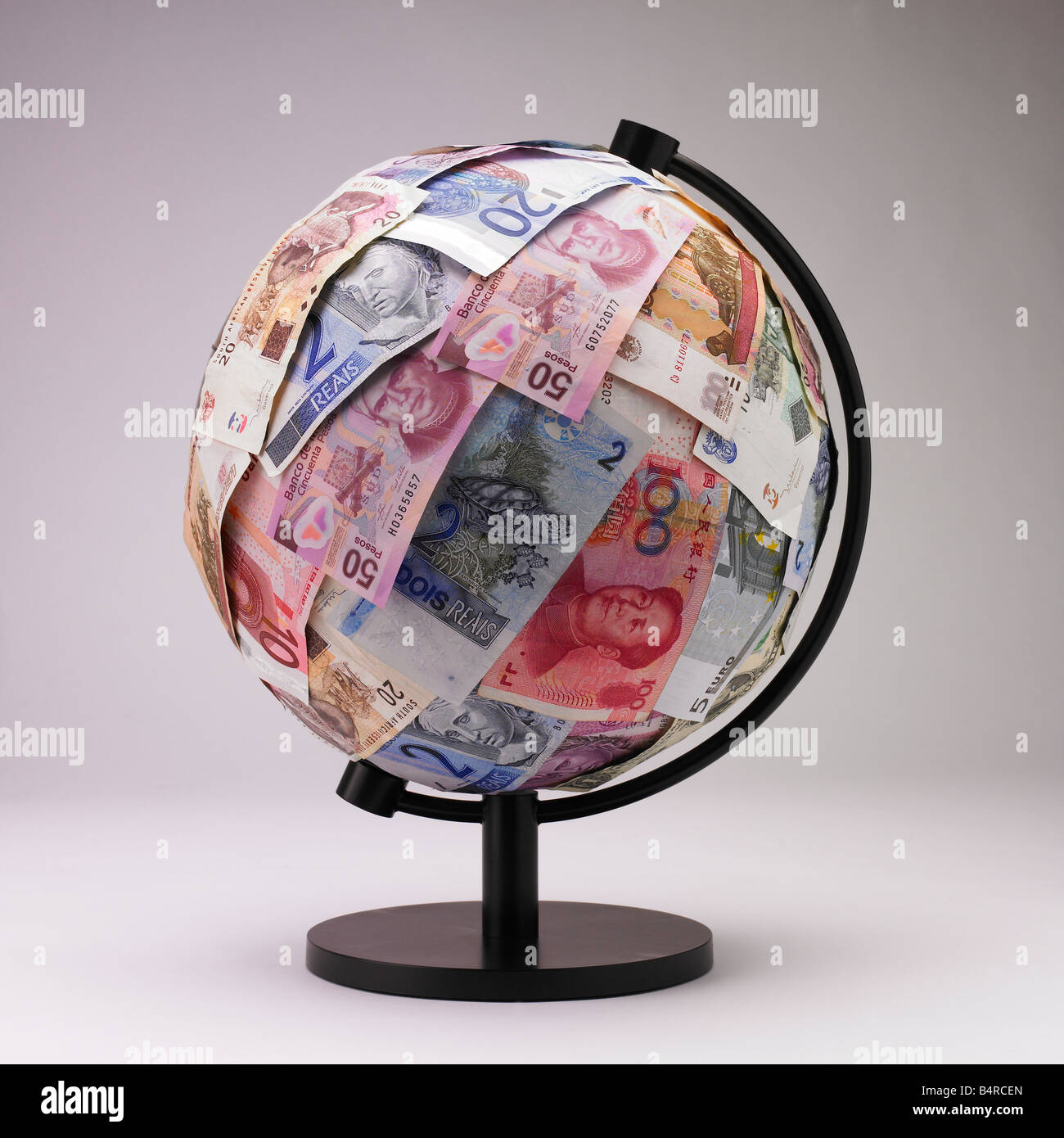 Globe covered in money Stock Photo - Alamy