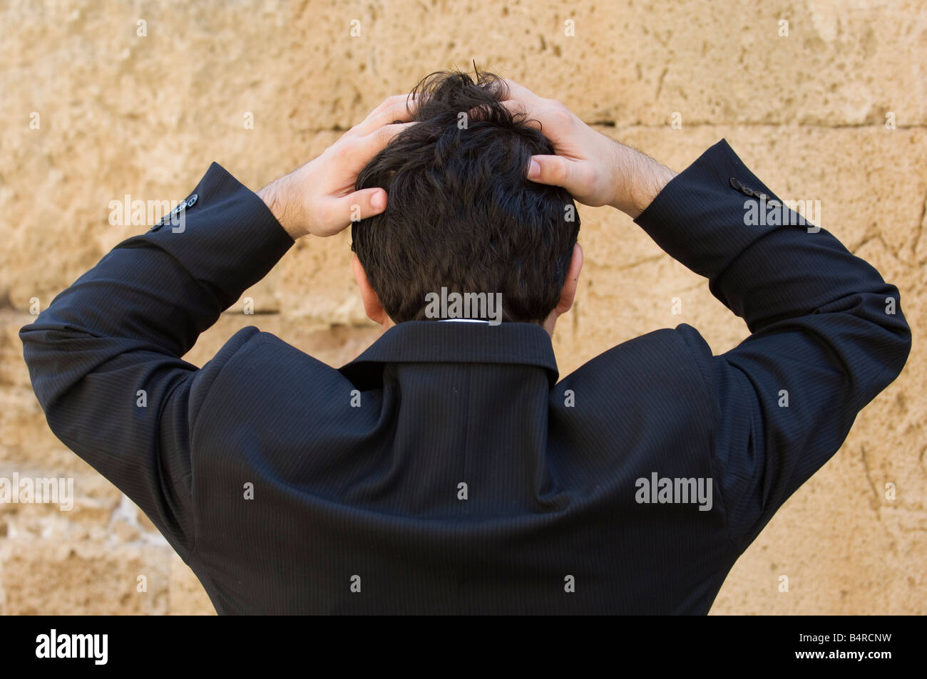 Business man pulling his hair Stock Photo - Alamy