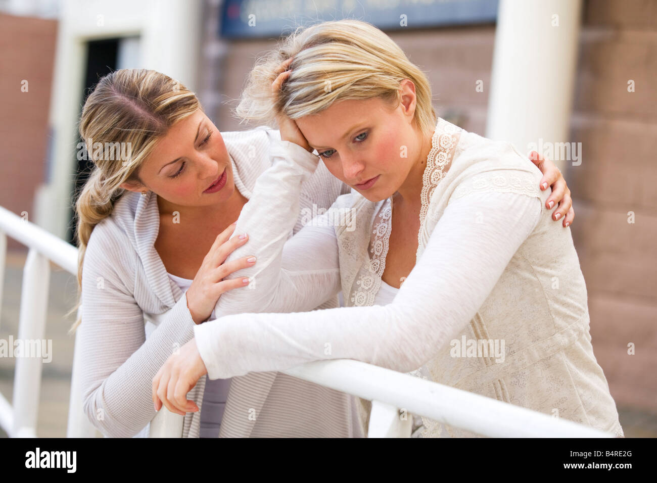 2 girls consoling Stock Photo - Alamy