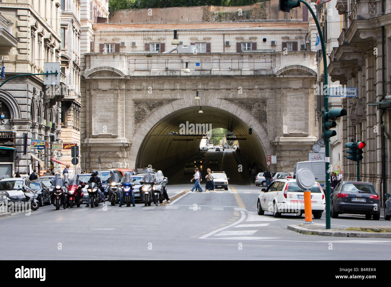 Cars and bikes waiting at the traffic lights after coming through a ...