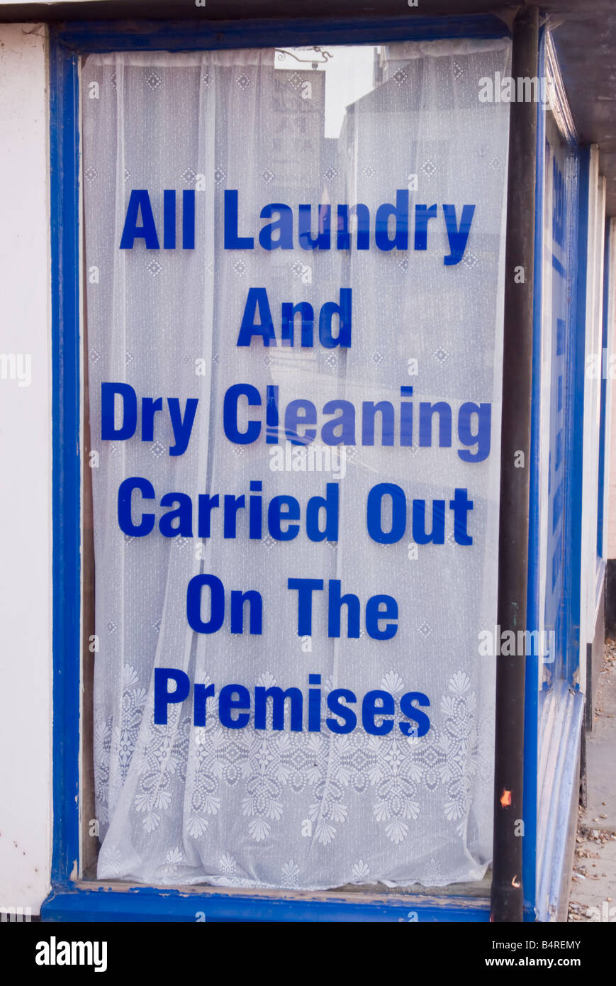 Laundry & dry cleaning services sign Stock Photo - Alamy
