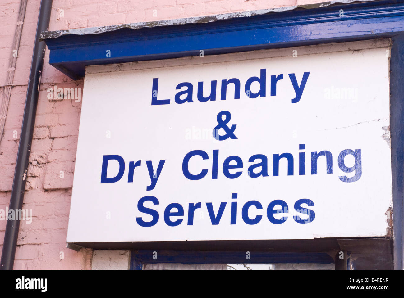 Laundry & dry cleaning services sign Stock Photo - Alamy