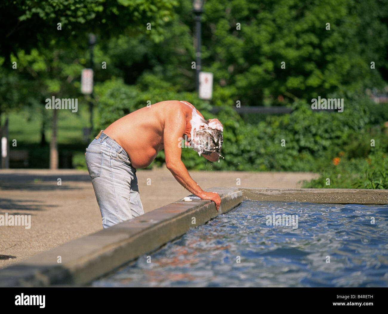 Homeless man washing hair hi-res stock photography and images - Alamy