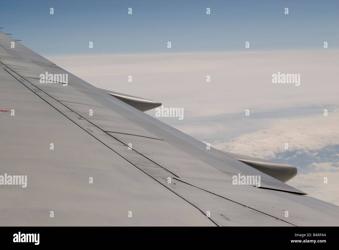 aerial view looking out the window over the wing of an airplane in ...