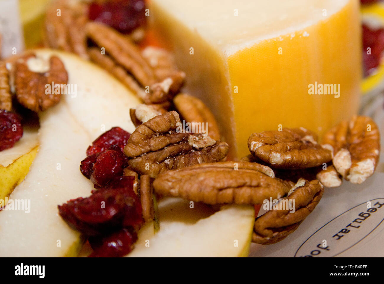 cheese dried fruit nuts and pear on a platter Stock Photo - Alamy