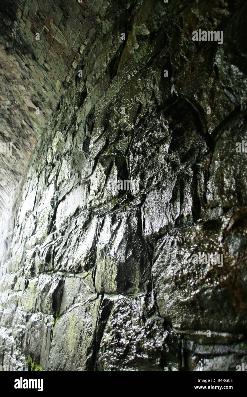 detail of dark damp wet stone wall in alley way Stock Photo - Alamy