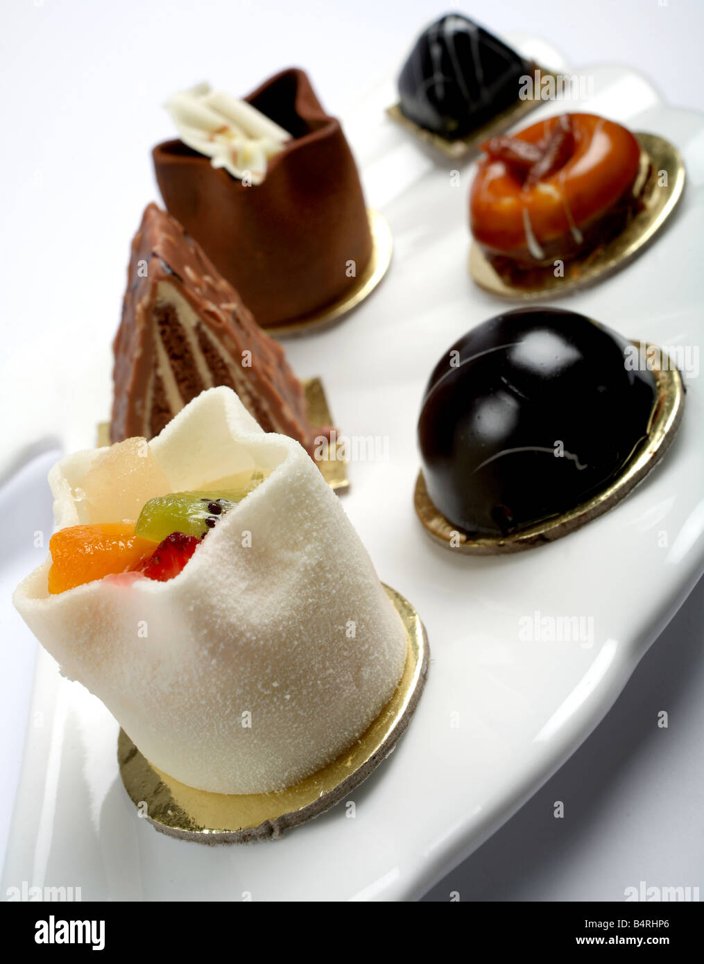 A group of varied gourmet cakes on a plate Stock Photo - Alamy