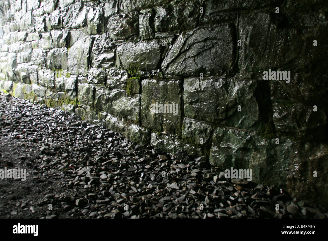 detail of dark damp wet stone wall in alley way Stock Photo - Alamy
