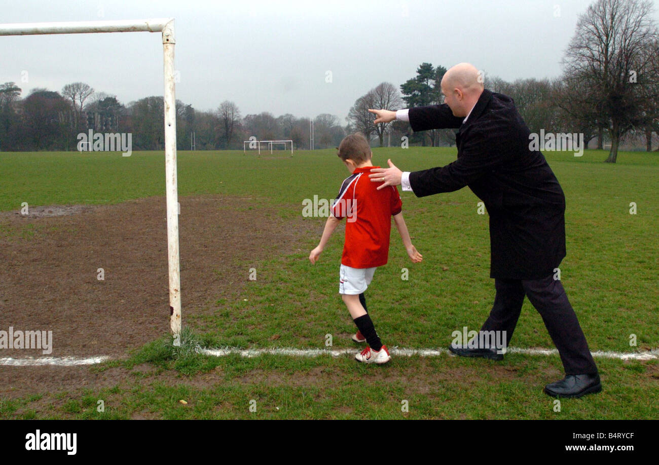 Pushy father encouraging his son to play footbal pic posed by models 21st March 2005 Stock Photo ...