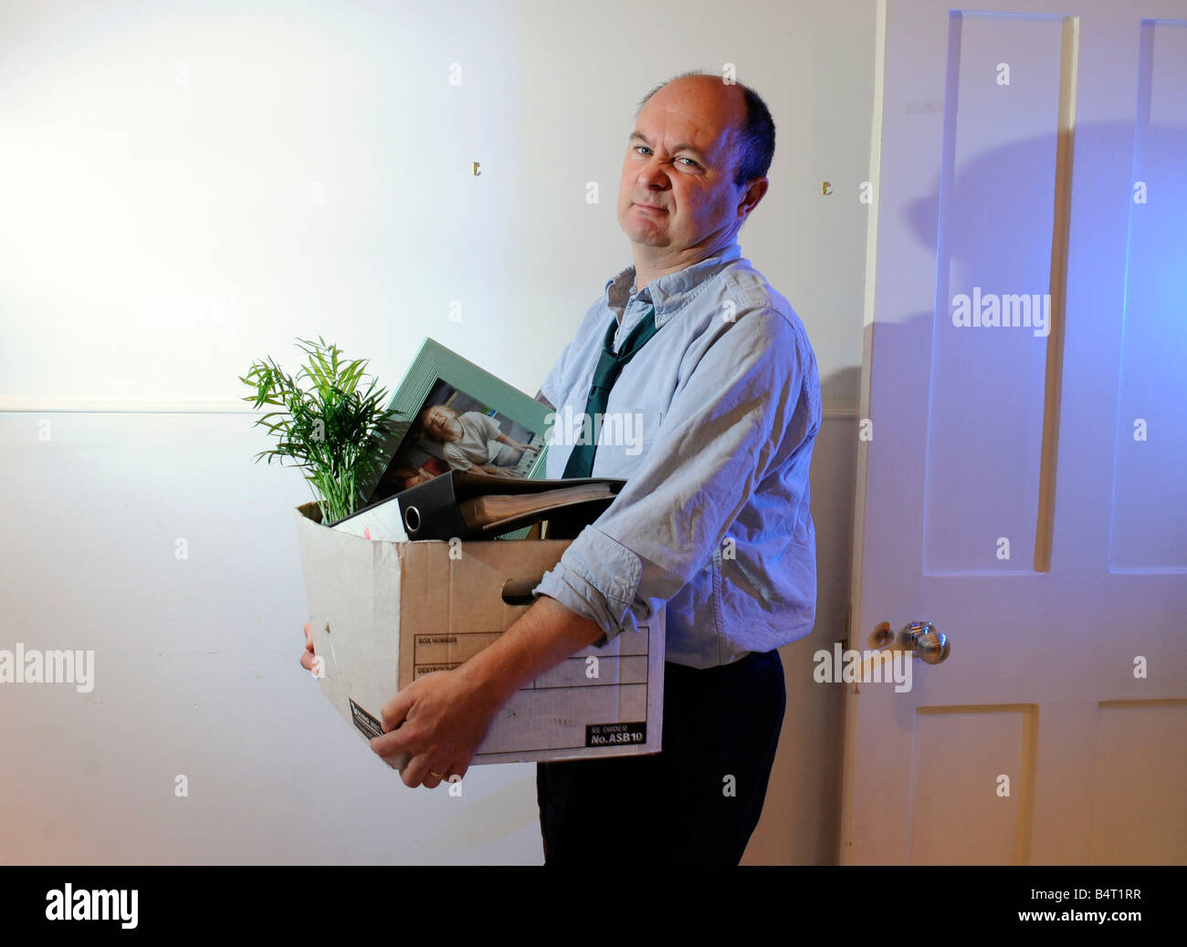 Man packs up and leaves the office after losing his job, being made ...