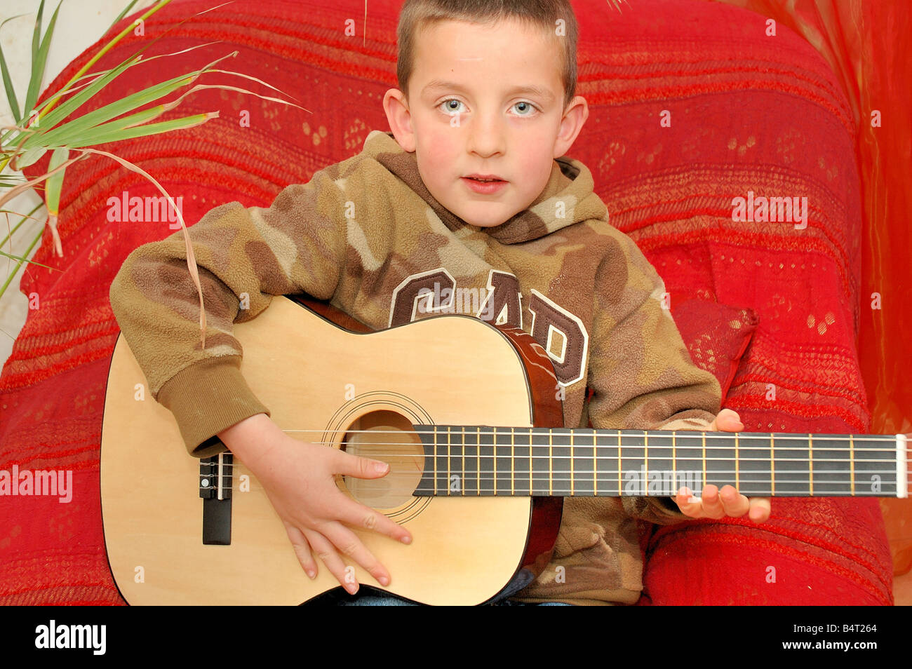 Boy playing guitar Stock Photo - Alamy