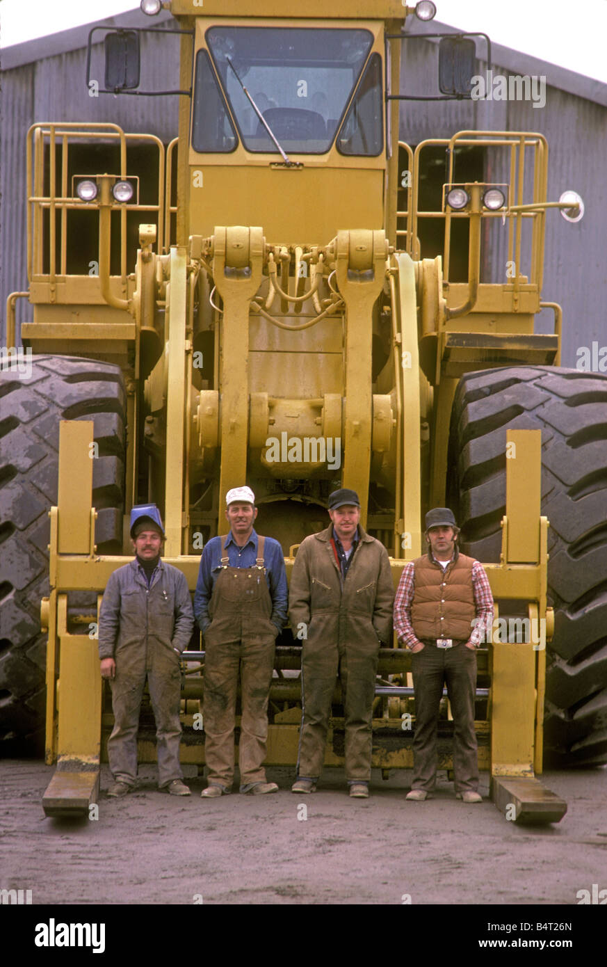men standing by bulldozer Stock Photo - Alamy