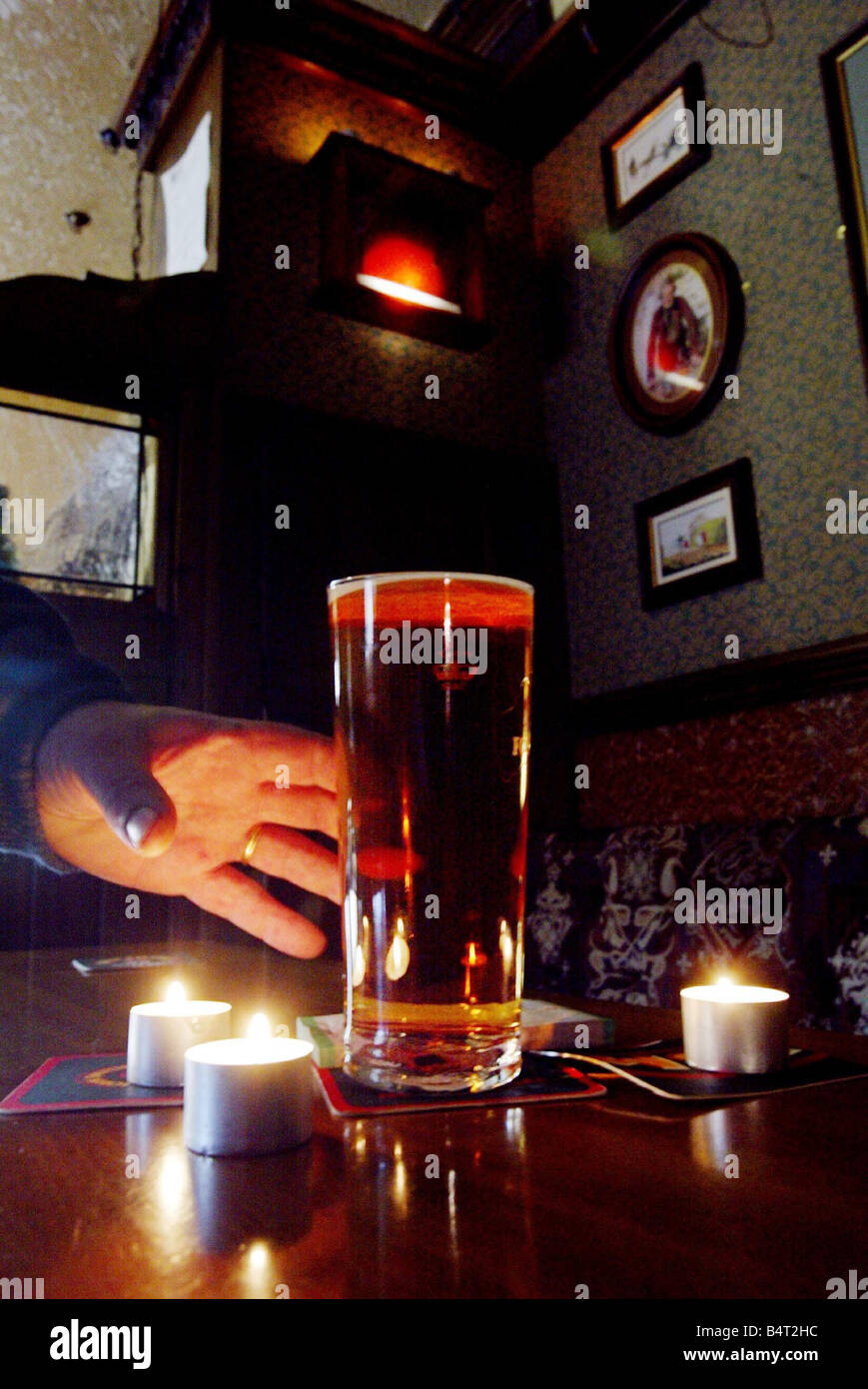 A pint of beer standing on a table Stock Photo - Alamy