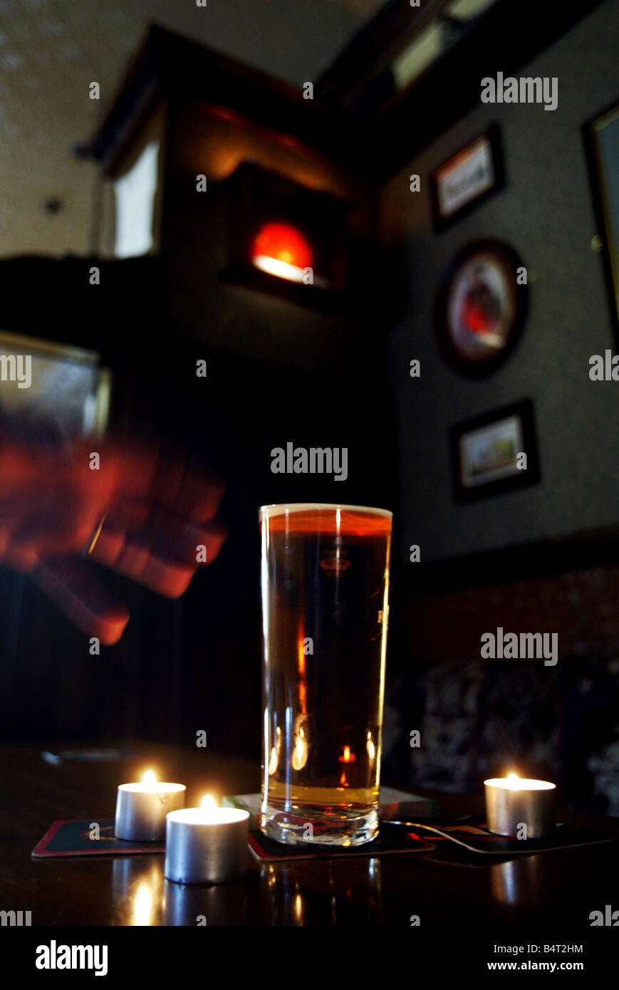 A pint of beer standing on a table Stock Photo - Alamy