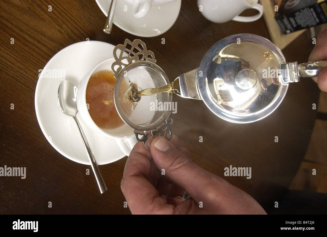 The perfect cup of tea straining the tea Stock Photo - Alamy