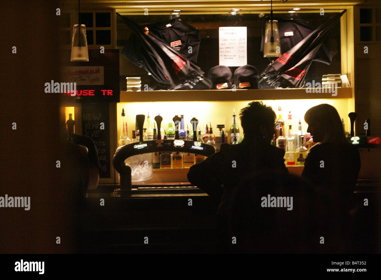 A group of friends drinking and enjoying a night out in bar Stock Photo ...