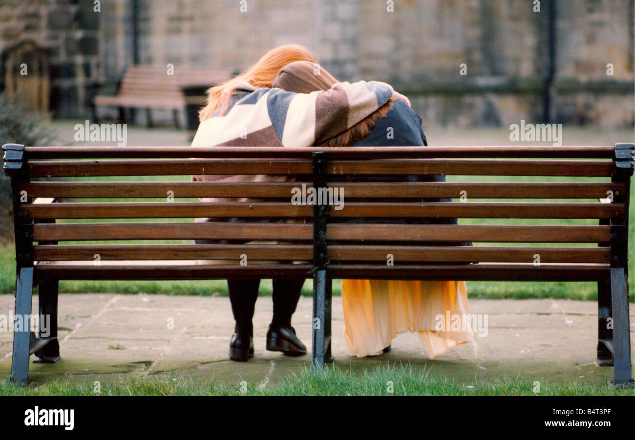 A stock picture of two people cuddling on a park bench This picture was ...