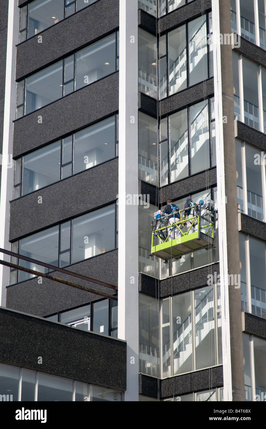 men in cradle painting the exterior of Lowthian House 1960 s brutalist ...