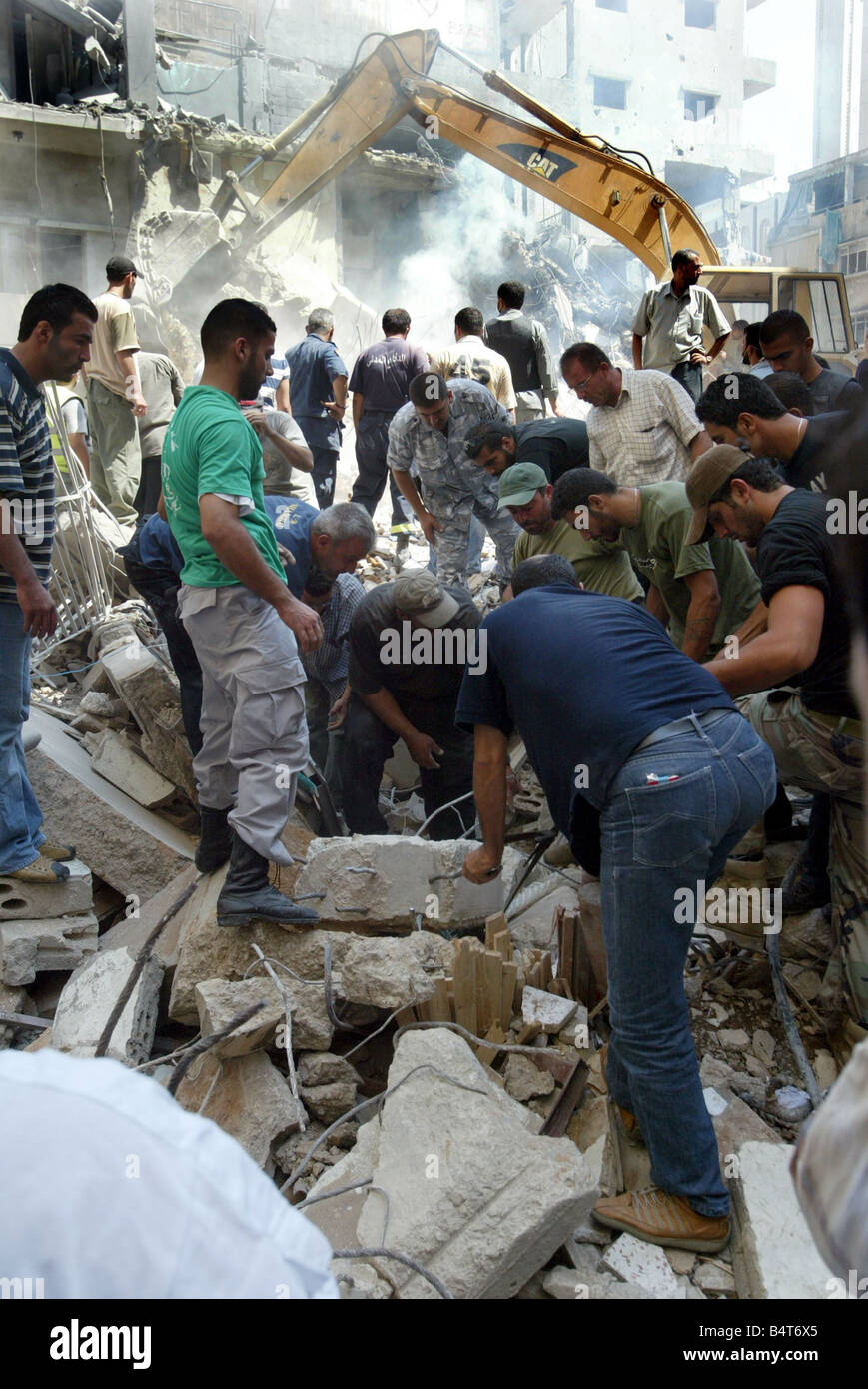 Lebanese civil defence workers and members of the public frantically ...
