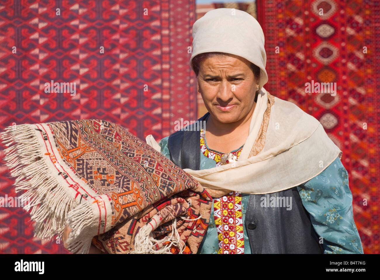 Turkmenistan, Ashgabat, (Ashkhabad), Tolkuchka Bazaar, Carpet seller ...