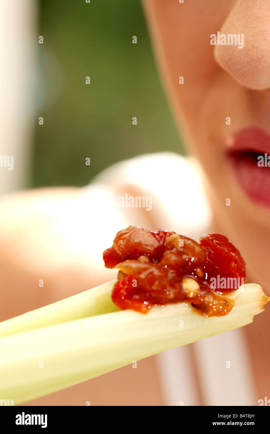 Woman Eating Celery and Salsa Model Released Stock Photo - Alamy