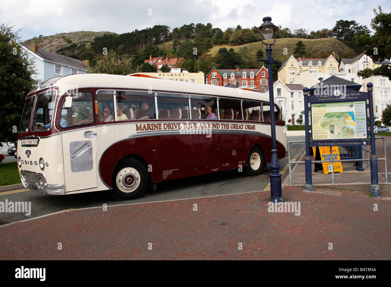 the great orme tour and marine drive bus leaving the stop along the ...