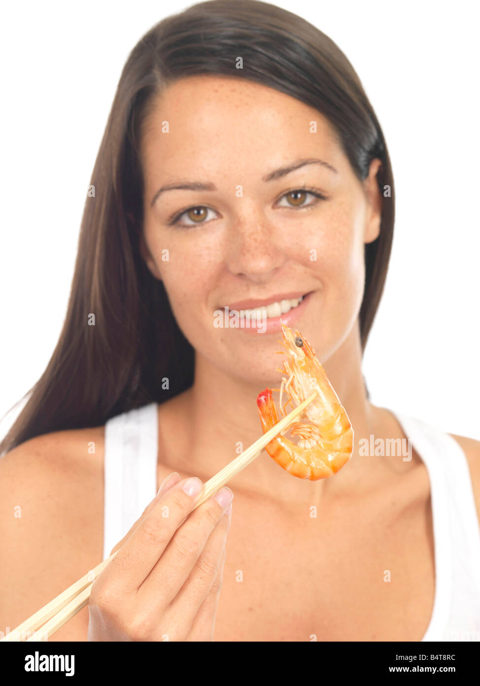 Healthy Young Woman Eating A Prawn Using Chopsticks Isolated Against A ...