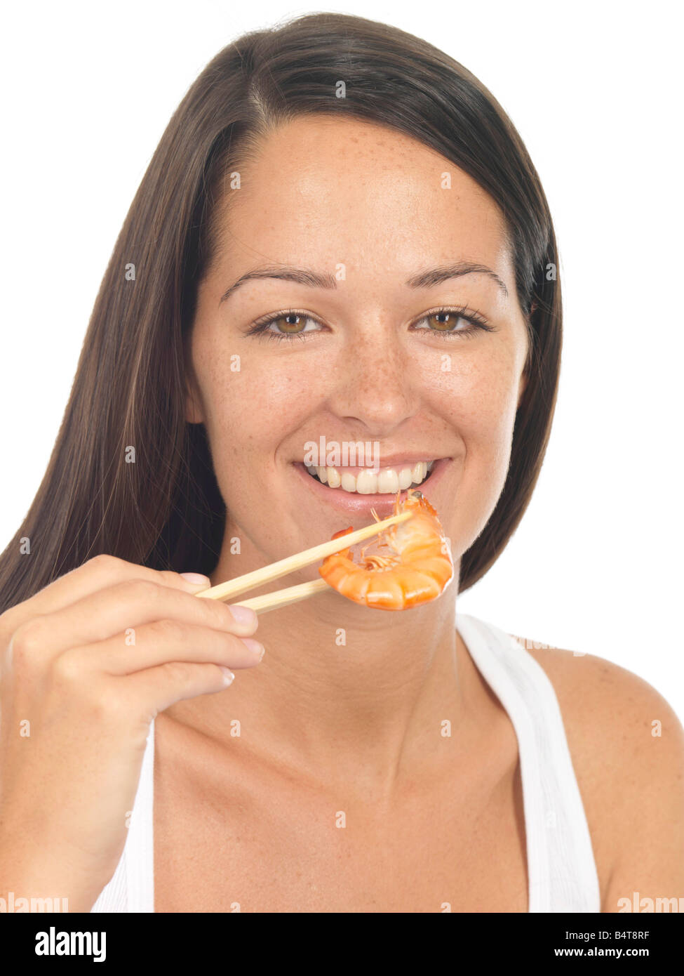 Healthy Young Woman Eating A Prawn Using Chopsticks Isolated Against A ...