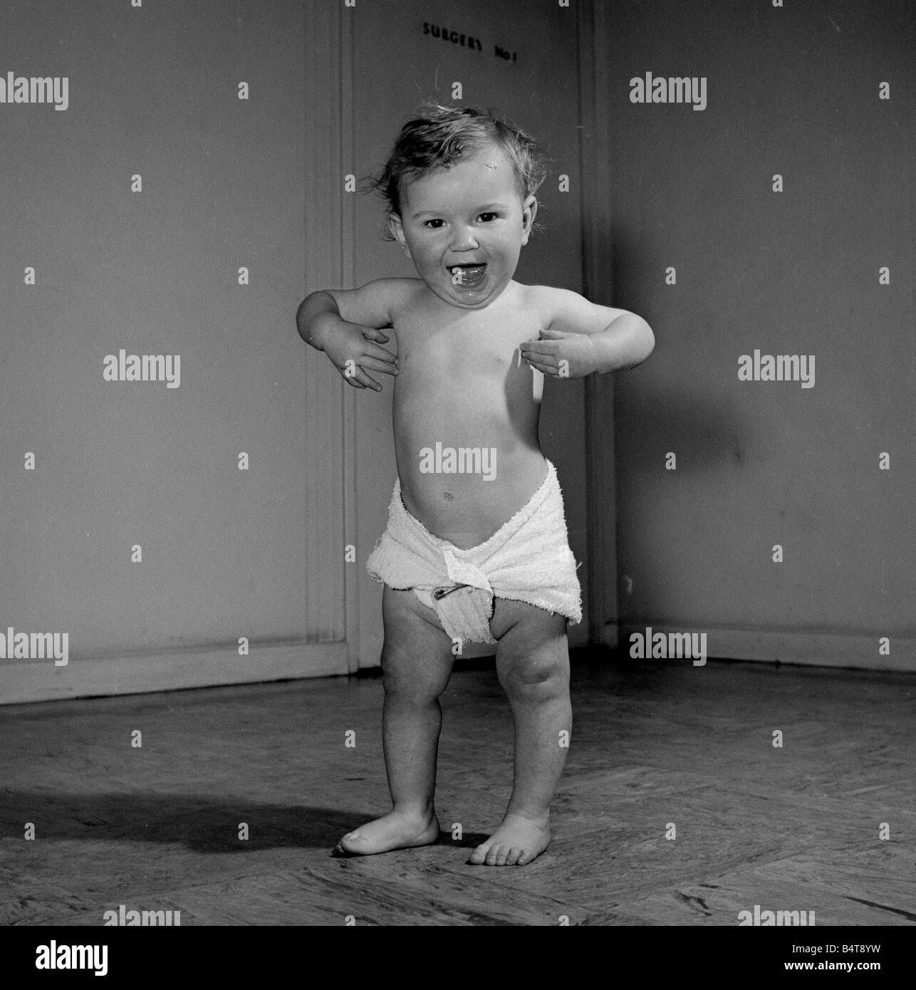 1957 National Health Service Baby Clinic A 14 month baby toddles about ...