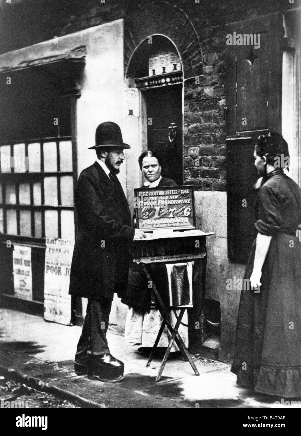 A street pedlar displays his wares in 1870 Stock Photo - Alamy