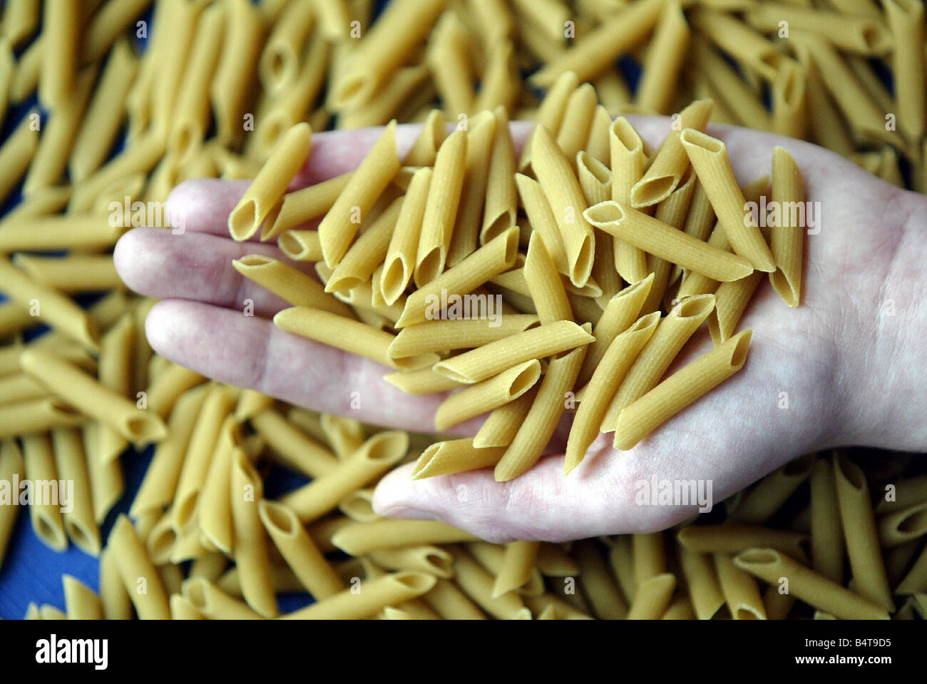 A handful of penne pasta Stock Photo - Alamy