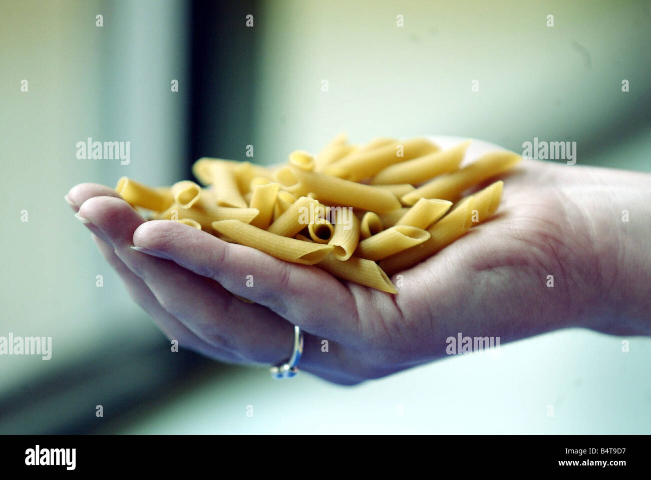A handful of penne pasta Stock Photo - Alamy