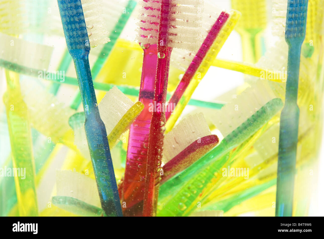 close up of submerged and floating brightly coloured toothbrushes in ...