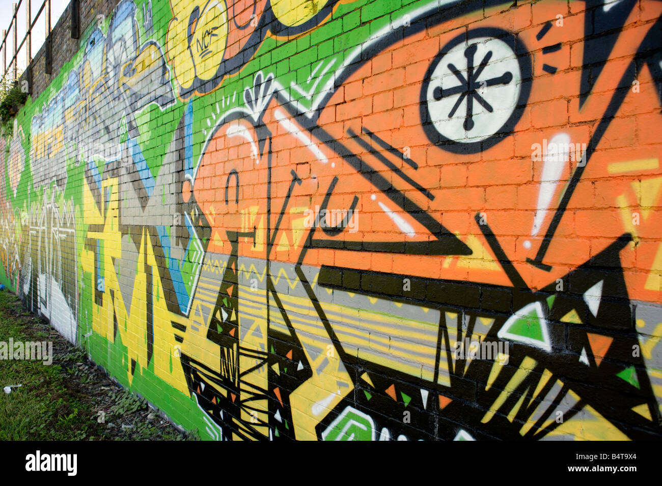 graffiti on the wall below a railway line art wallart community project ...